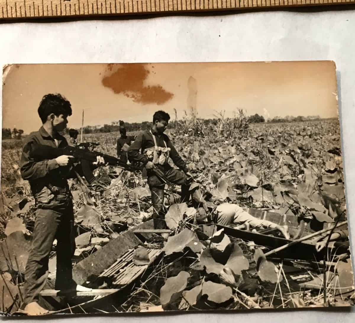 Photograph of Viet Cong Removing PRC25 from a KIA ARVN - Enemy Militaria